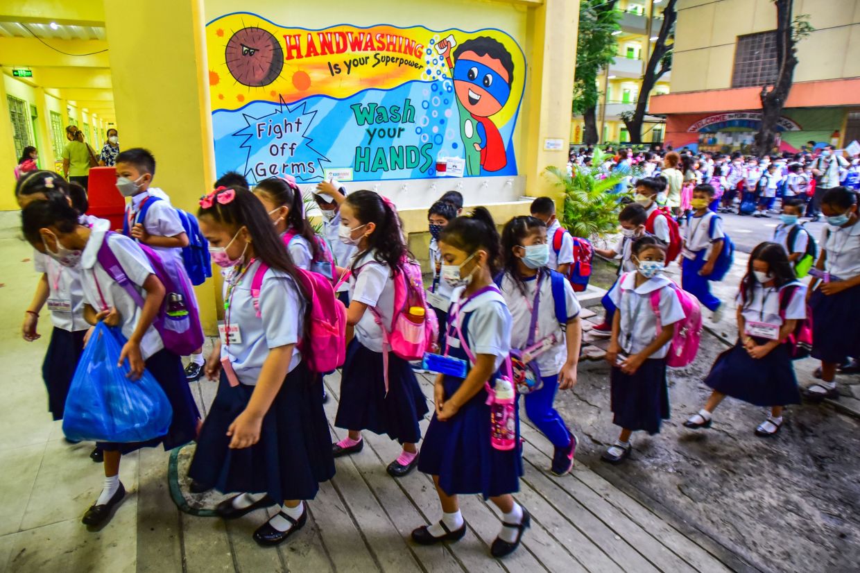 Students and teachers return with mixed feelings as Philippine schools reopen their doors | The Star
