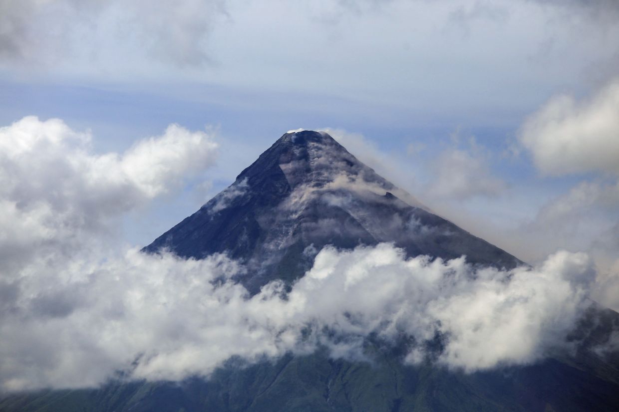Philippines' Mayon Volcano spews lava down its slopes in gentle ...