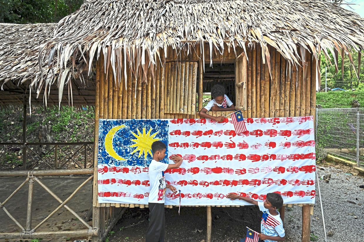 Orang Asli handprints transform into stunning Jalur Gemilang | The Star