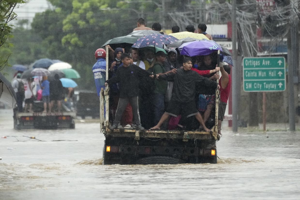 Tropical storm triggers flood and landslides in Philippines, 11 dead ...