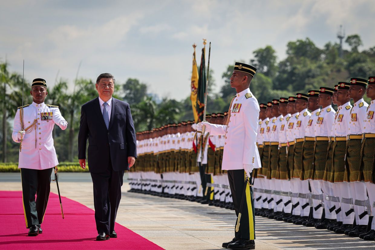 In pictures: China's President Xi accorded state welcome at Istana ...